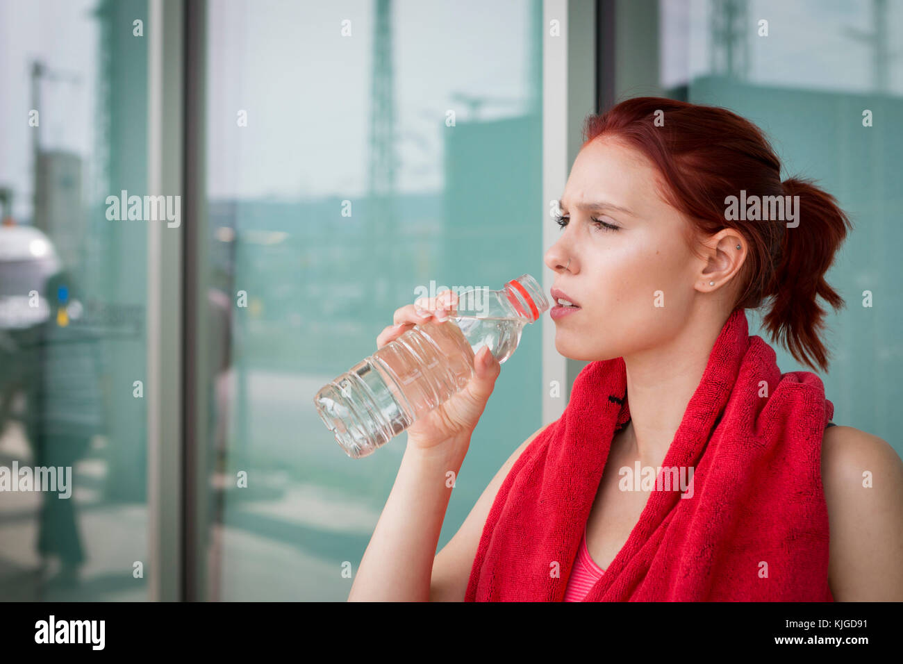 Young athlete taking a break, drinking water Stock Photo - Alamy