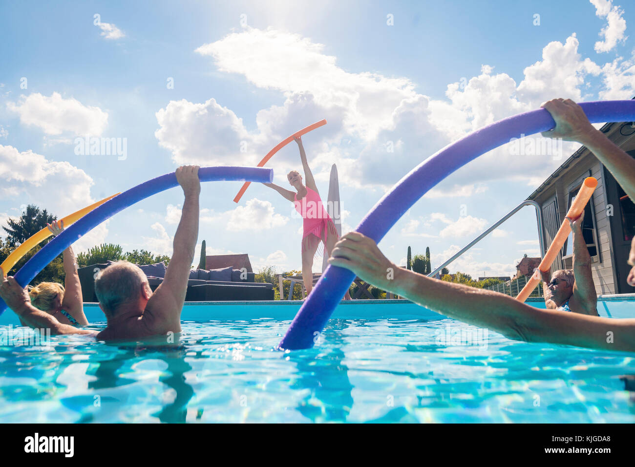 Group of seniors with trainer doing water gymnastics in pool Stock ...
