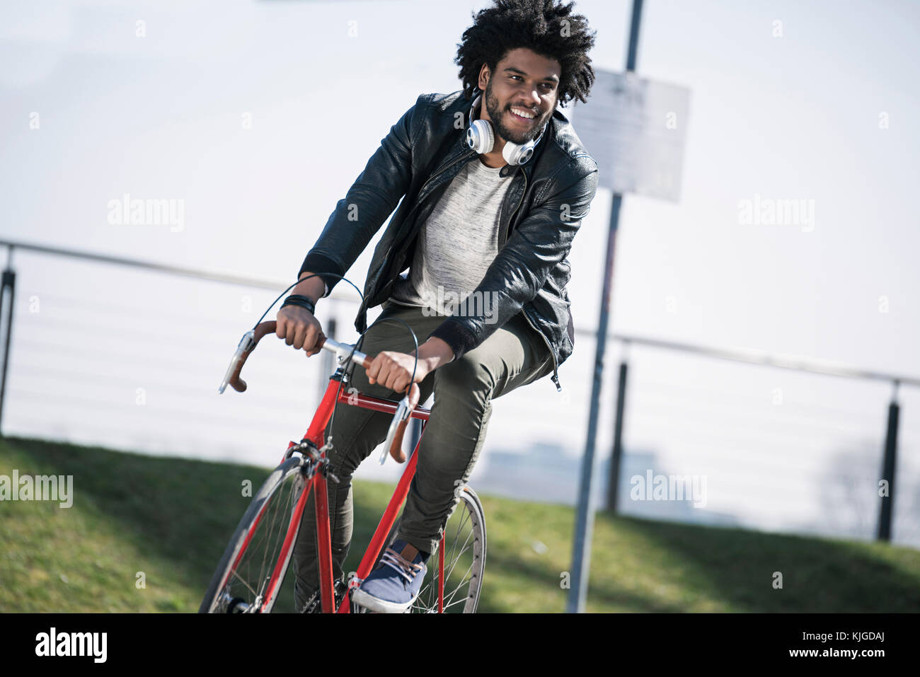 Smiling man riding bicycle Stock Photo - Alamy