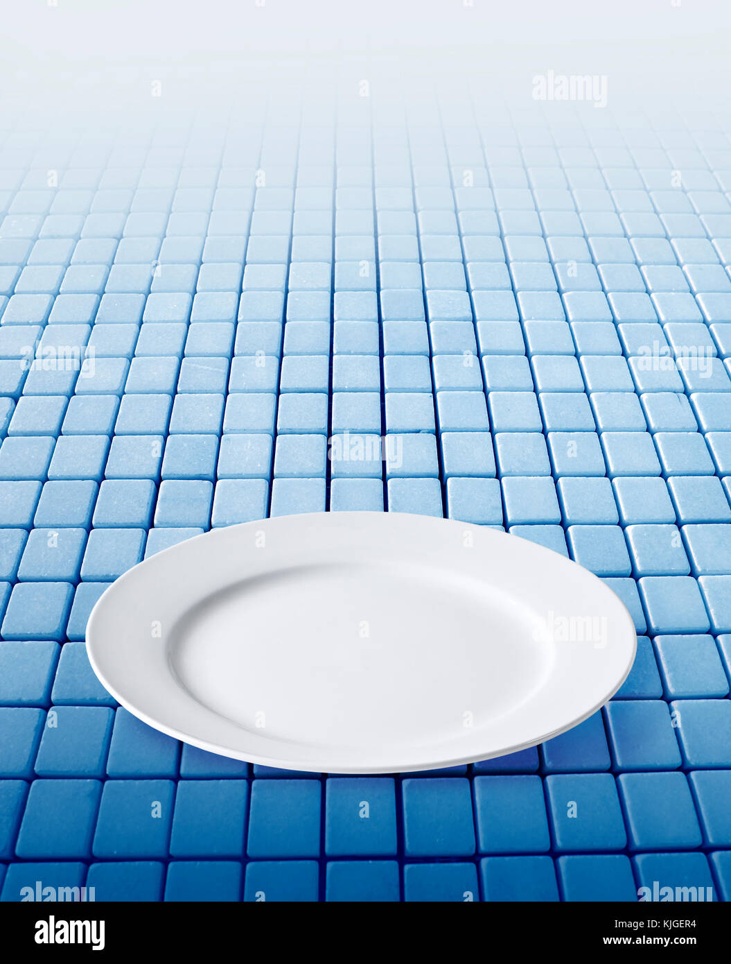 Empty plate on ablue background Stock Photo - Alamy