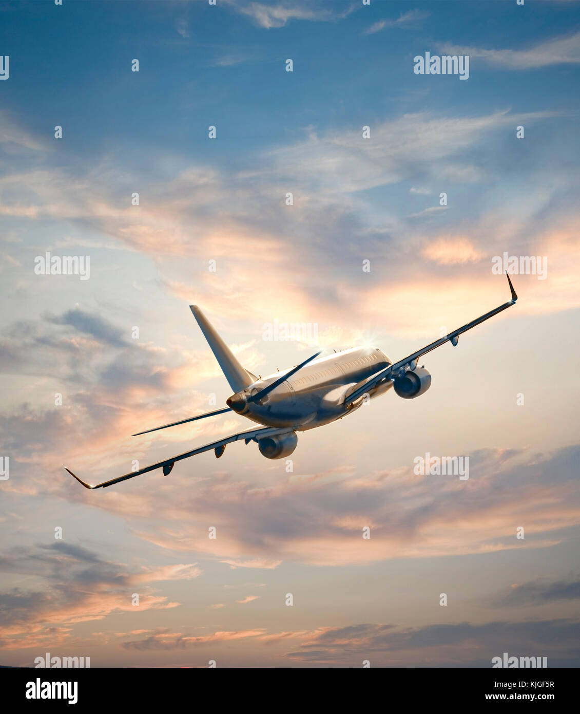 Airplane flying in the beautiful sky through the clouds at sunset Stock ...