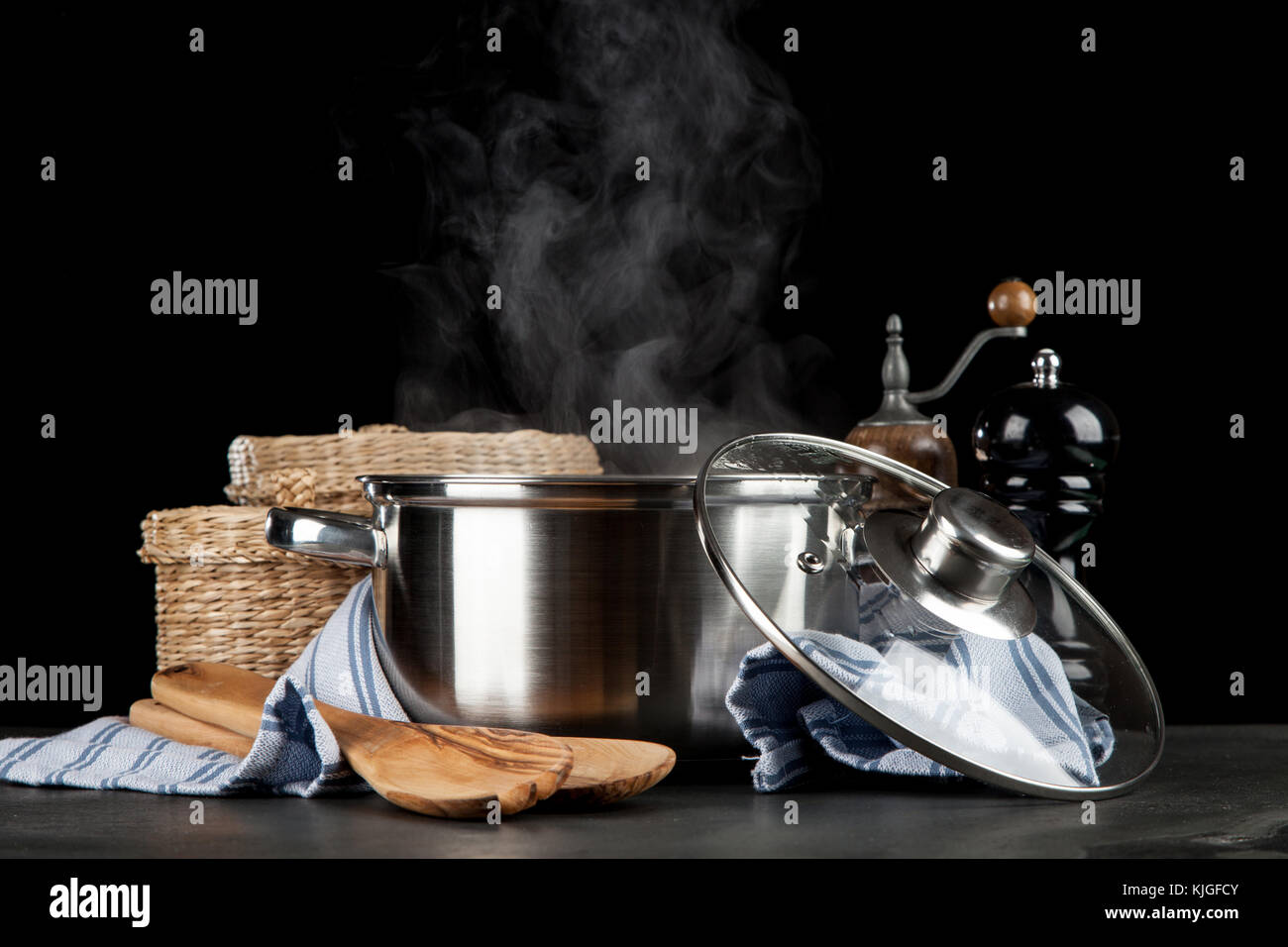 Steaming pot on black background Stock Photo - Alamy