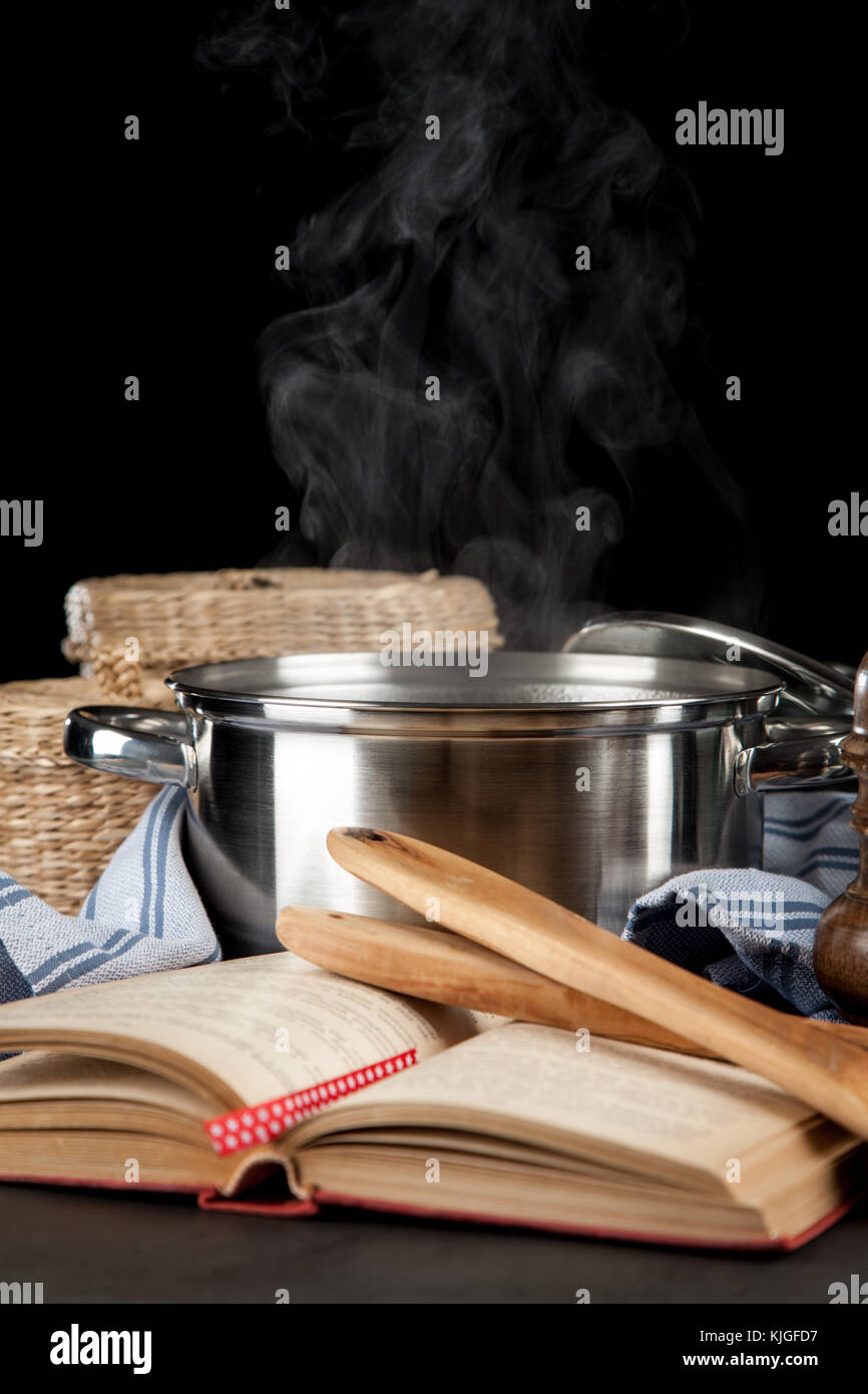 Steaming pot on black background Stock Photo - Alamy