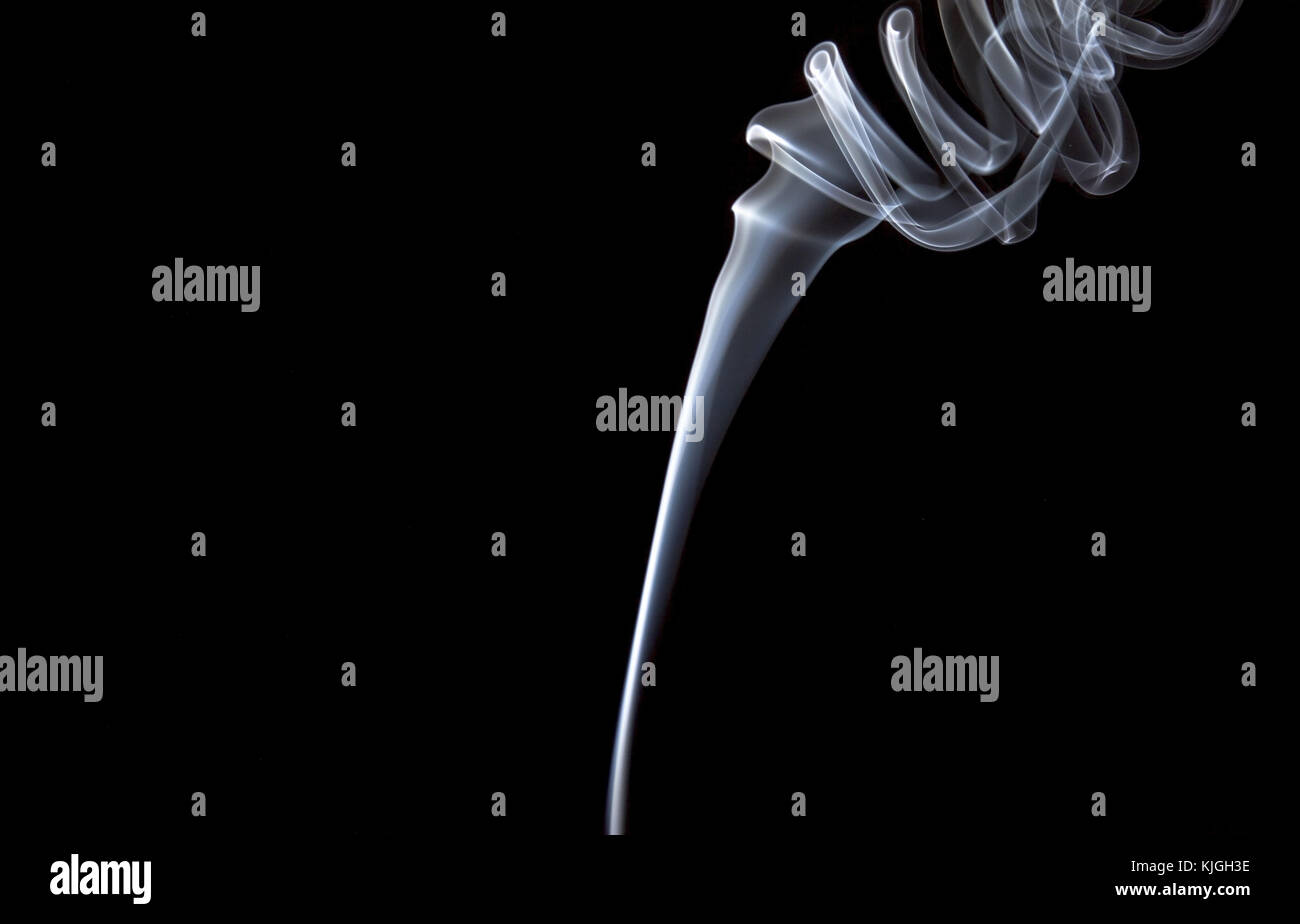 Smoke volutes on a pure black background Stock Photo - Alamy