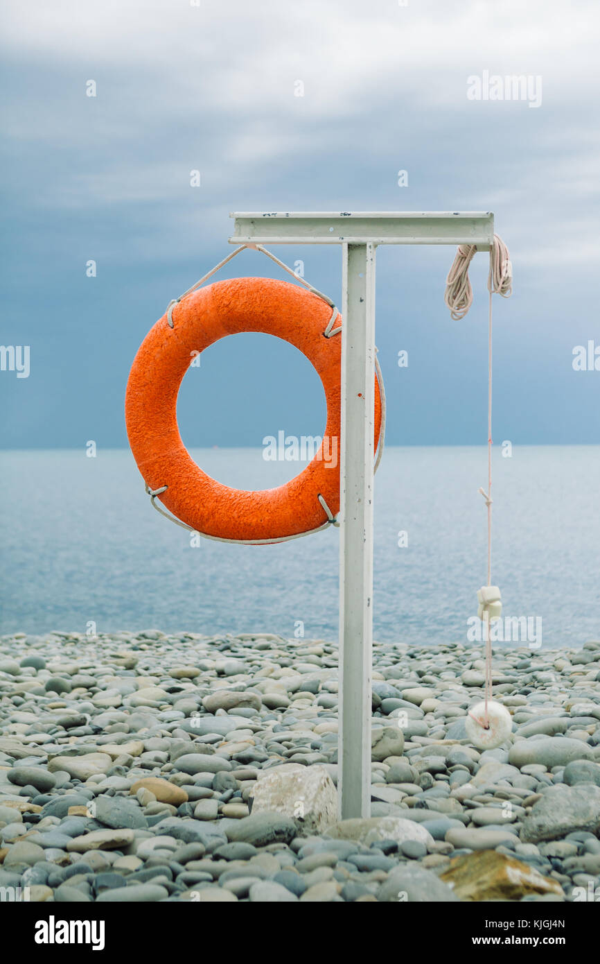 orange lifebuoy on the sea coast Stock Photo - Alamy