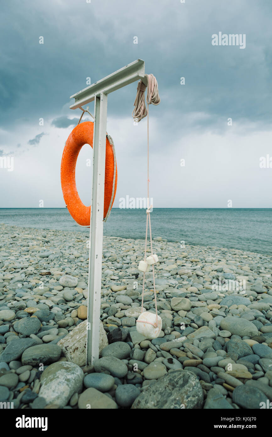 orange lifebuoy on the sea coast Stock Photo - Alamy