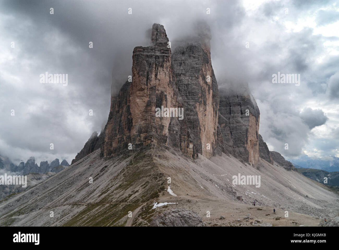 Side profile of cloud-covered Drei Zinnen, Dolomites, Italy Stock Photo ...