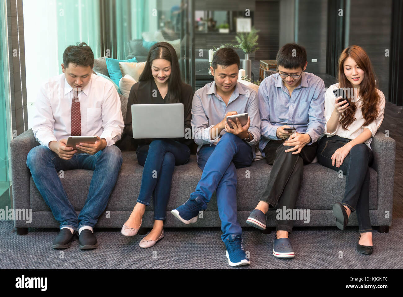Group Of Asian Business people with casual suit using the technology ...