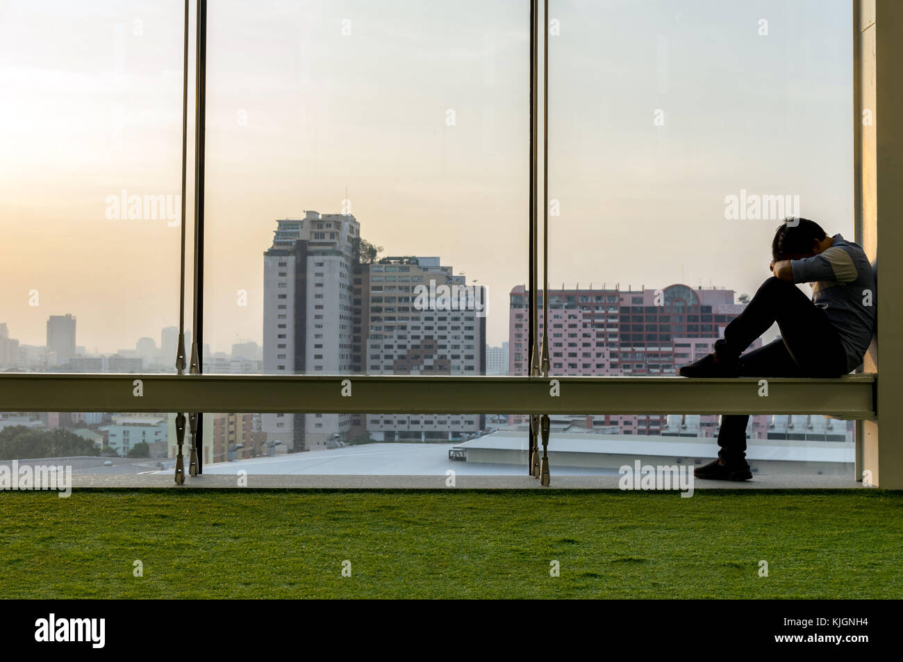Sad businessman sitting head in hands on the the modern creative Office ...