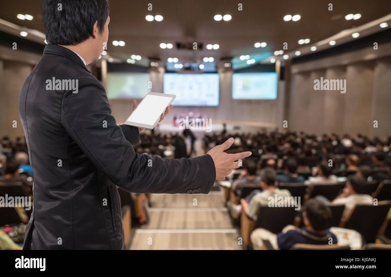 Rear view of Business People Conference Speaker on over the Abstract ...