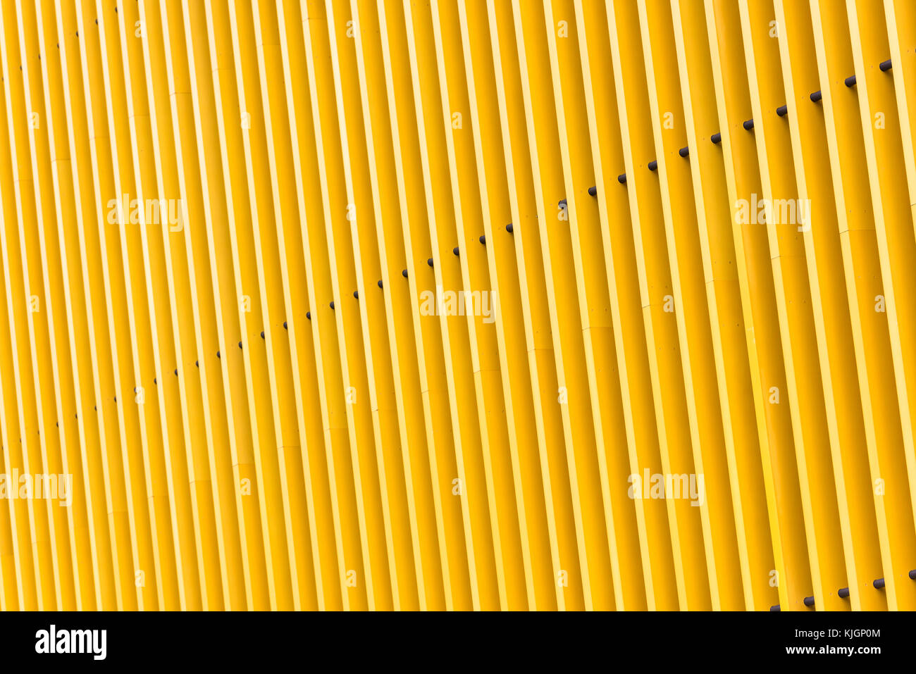Detail of bright yellow metal building facade. For background Stock ...
