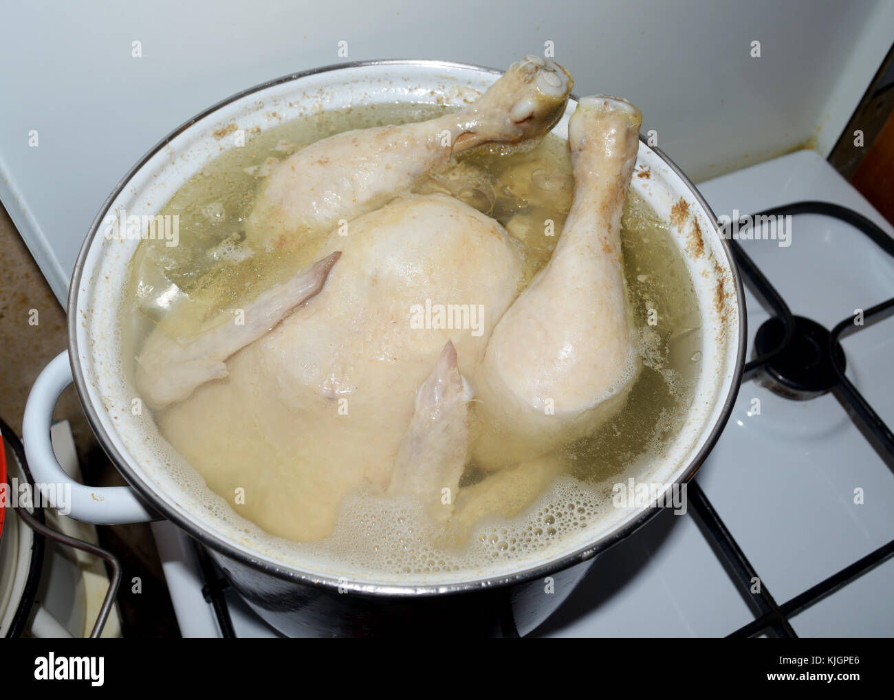 Big chicken is cooked in a saucepan on a gas stove Stock Photo - Alamy