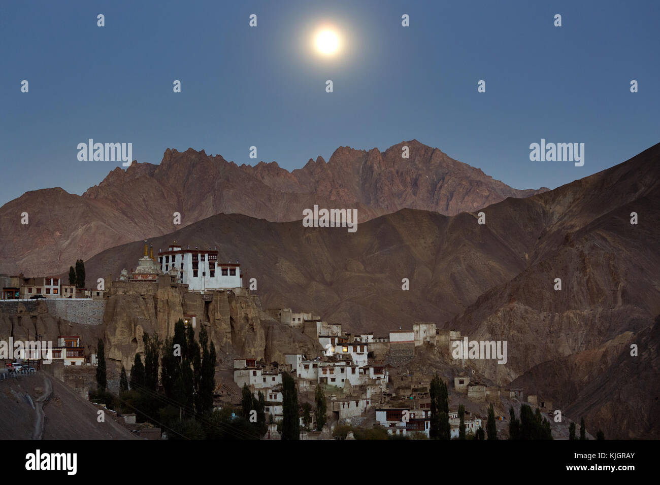 Evening picture of Lamayuru monastery with full moon over the mountains ...