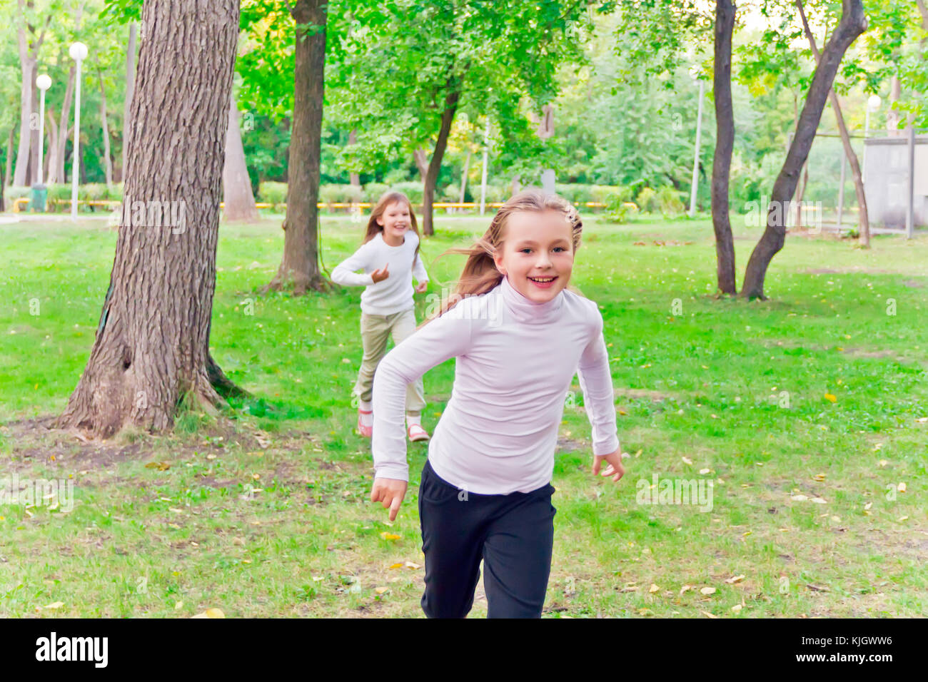 Photo of two running girls in summer Stock Photo - Alamy