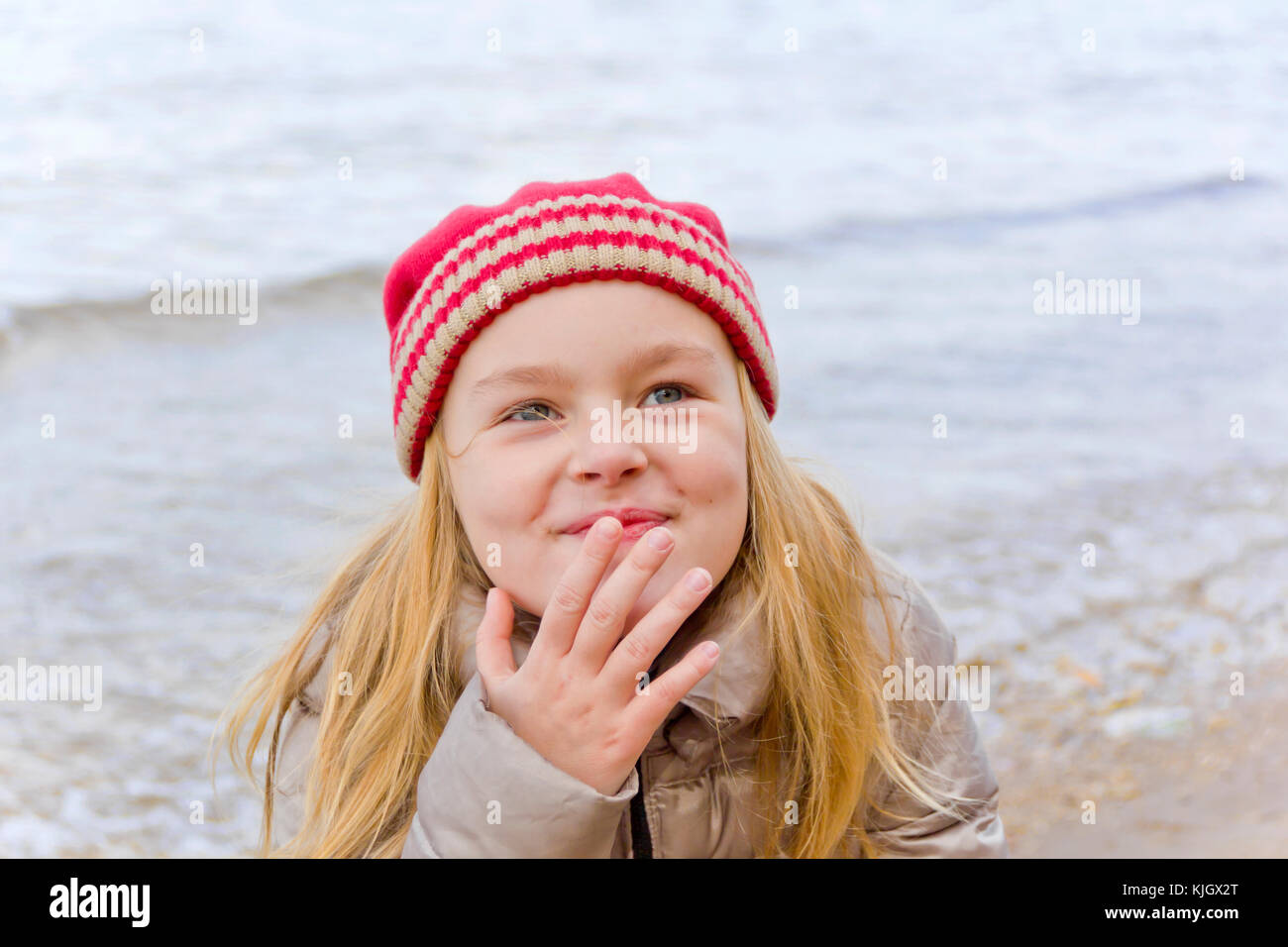 Beautiful Red Hat smiling girl on riverside Stock Photo - Alamy