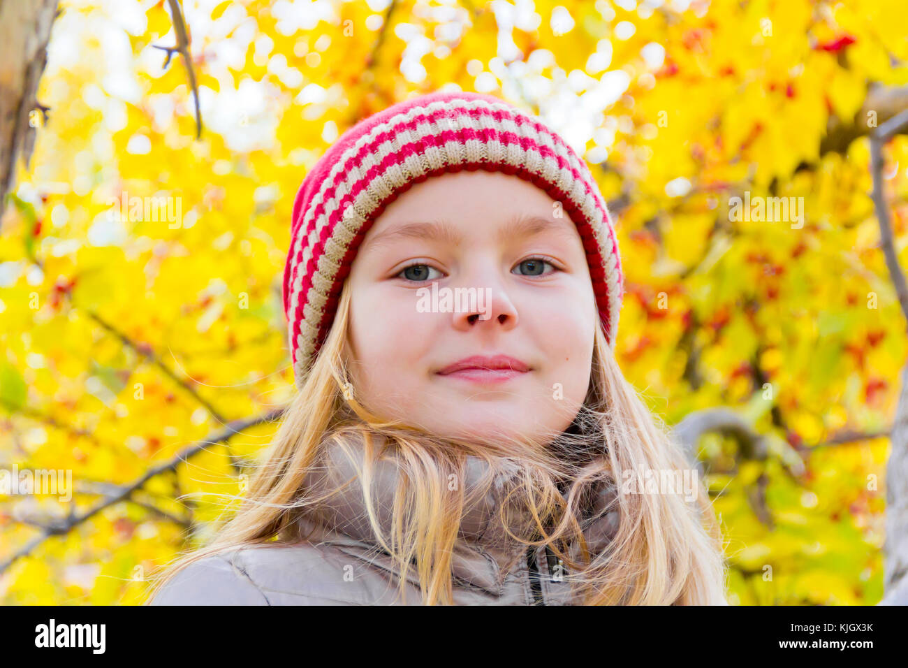 Portrait of cute smiling girl in red hat Stock Photo - Alamy