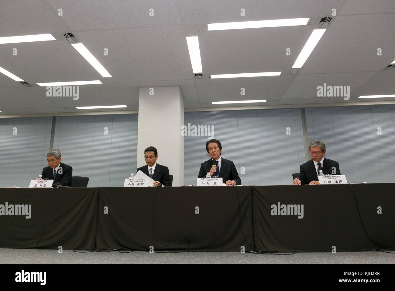 Akira Takeuchi (C-R) president of Mitsubishi Materials Corp. speaks ...