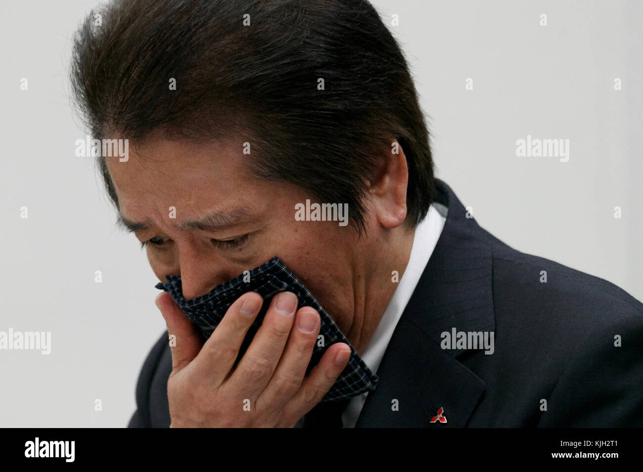 Akira Takeuchi, president of Mitsubishi Materials Corp., cleans his ...