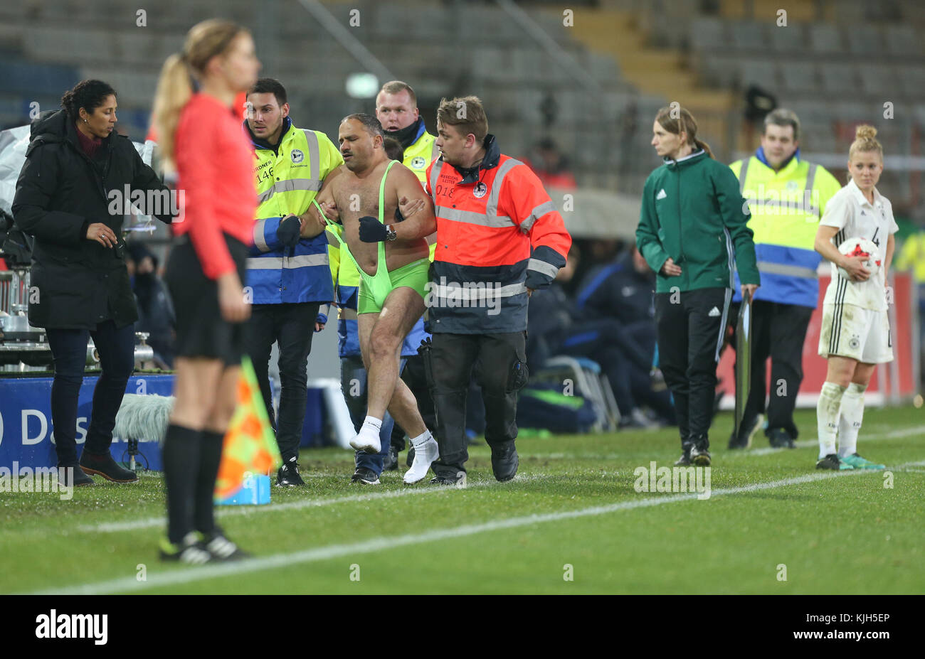 Bielefeld, Germany. 24th Nov, 2017. A streaker is led from the field ...