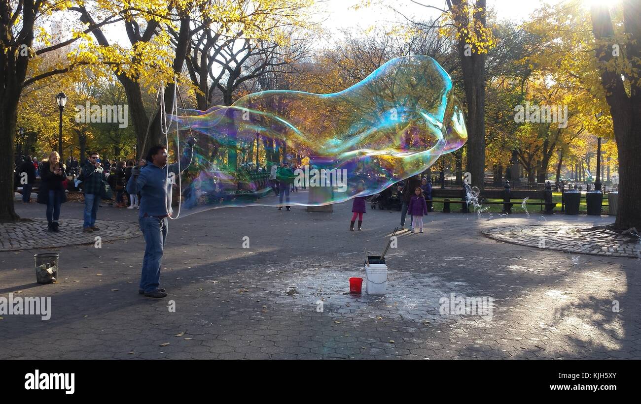 New York, United States. 24th Nov, 2017. A man blows large bubbles in ...