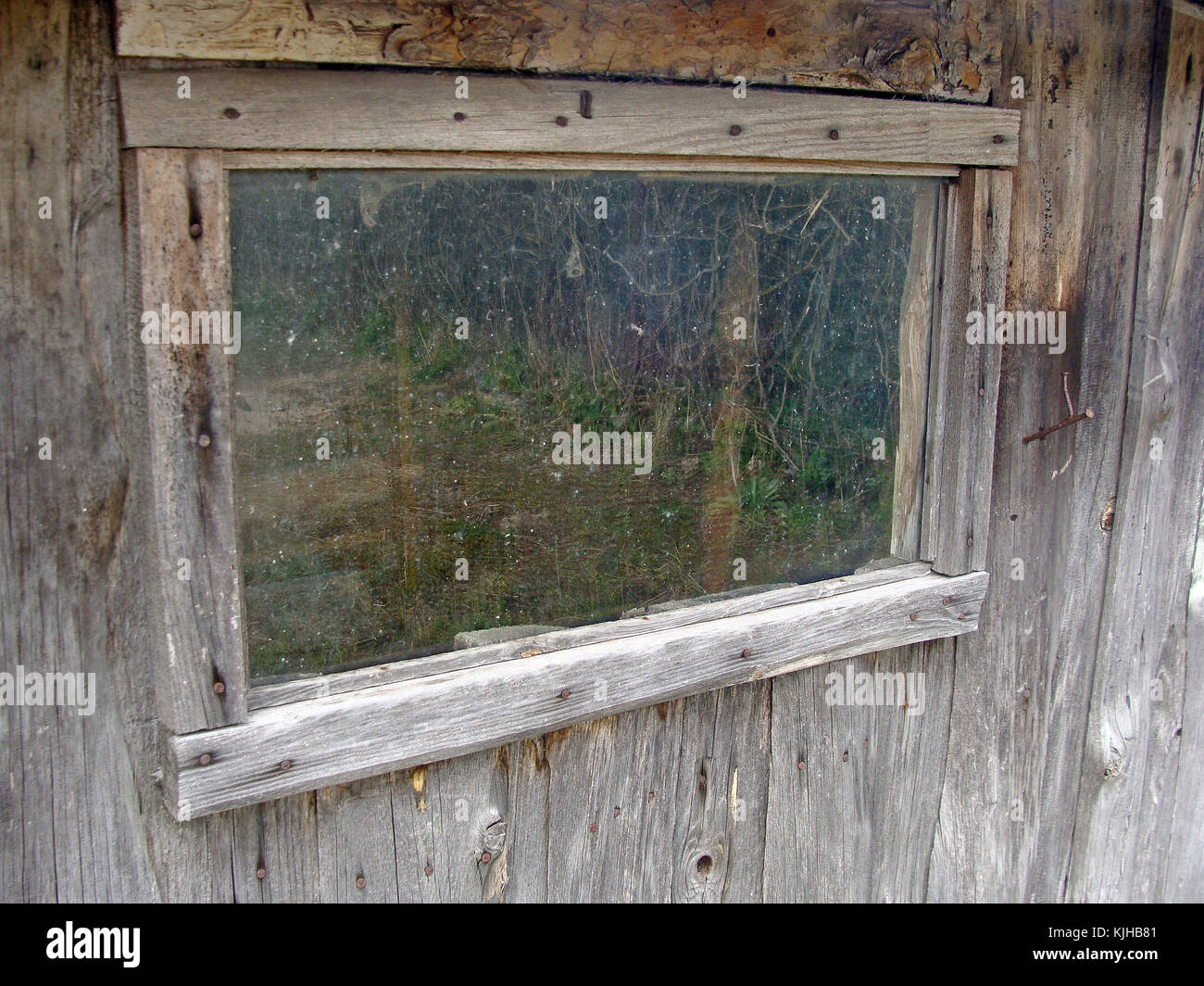 Old small glass window on weathered wooden barn wall Stock Photo - Alamy