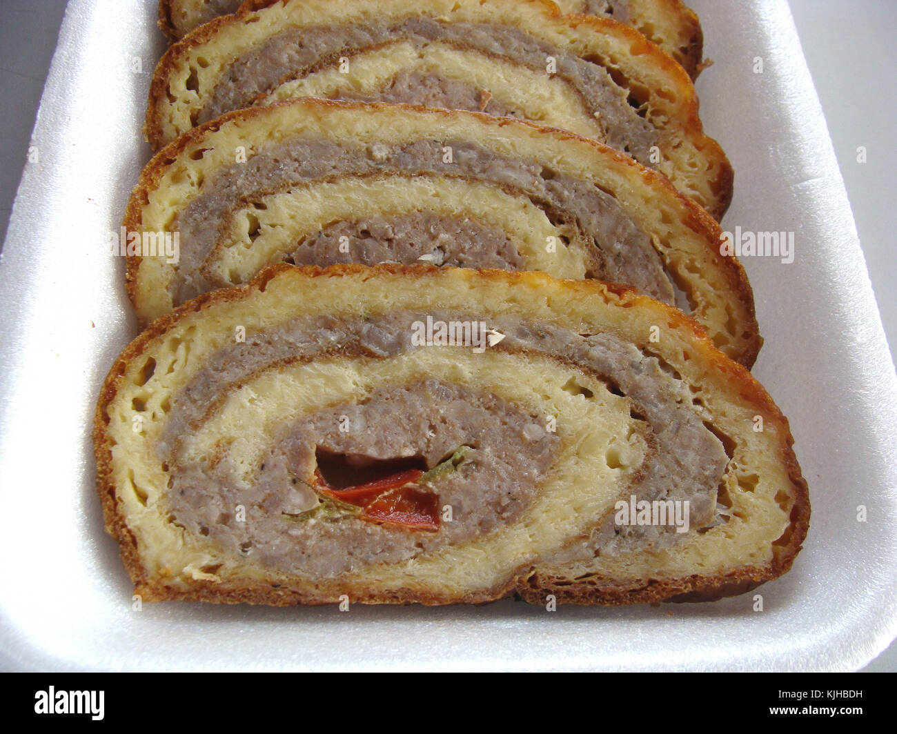 Sliced meat roulette or rolls on plastic box close up Stock Photo - Alamy