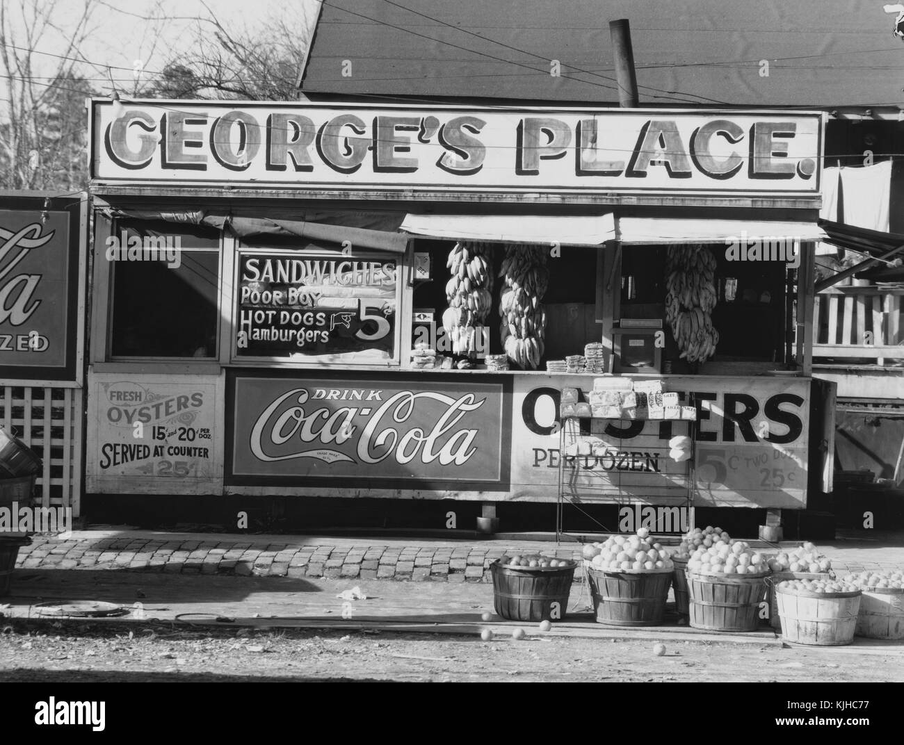 Black and white photograph of a roadside food stand that reads 'George ...