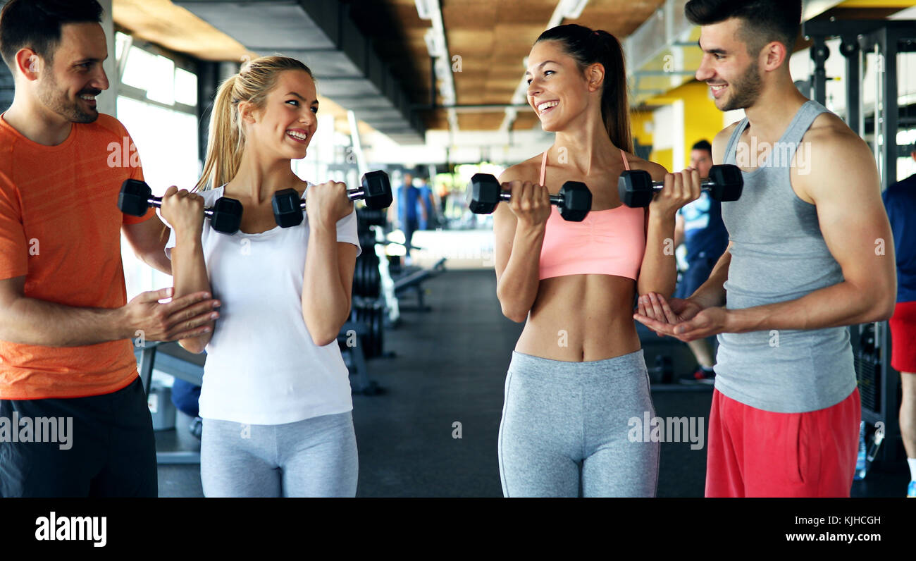Group of friends exercising together in gym Stock Photo - Alamy