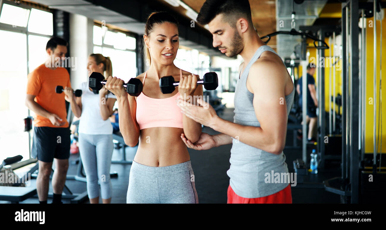 Group of friends exercising together in gym Stock Photo - Alamy