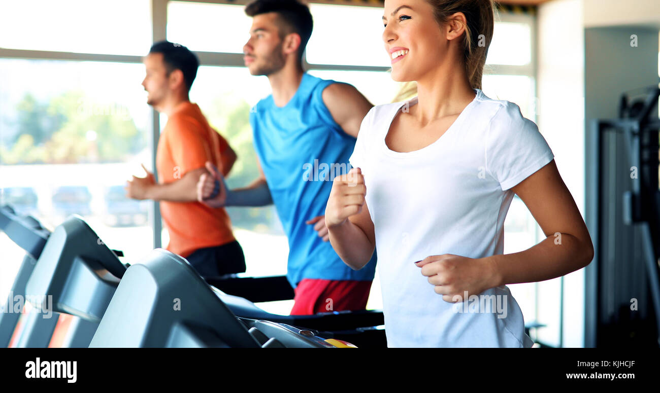 Group of friends exercising on treadmill machine Stock Photo - Alamy