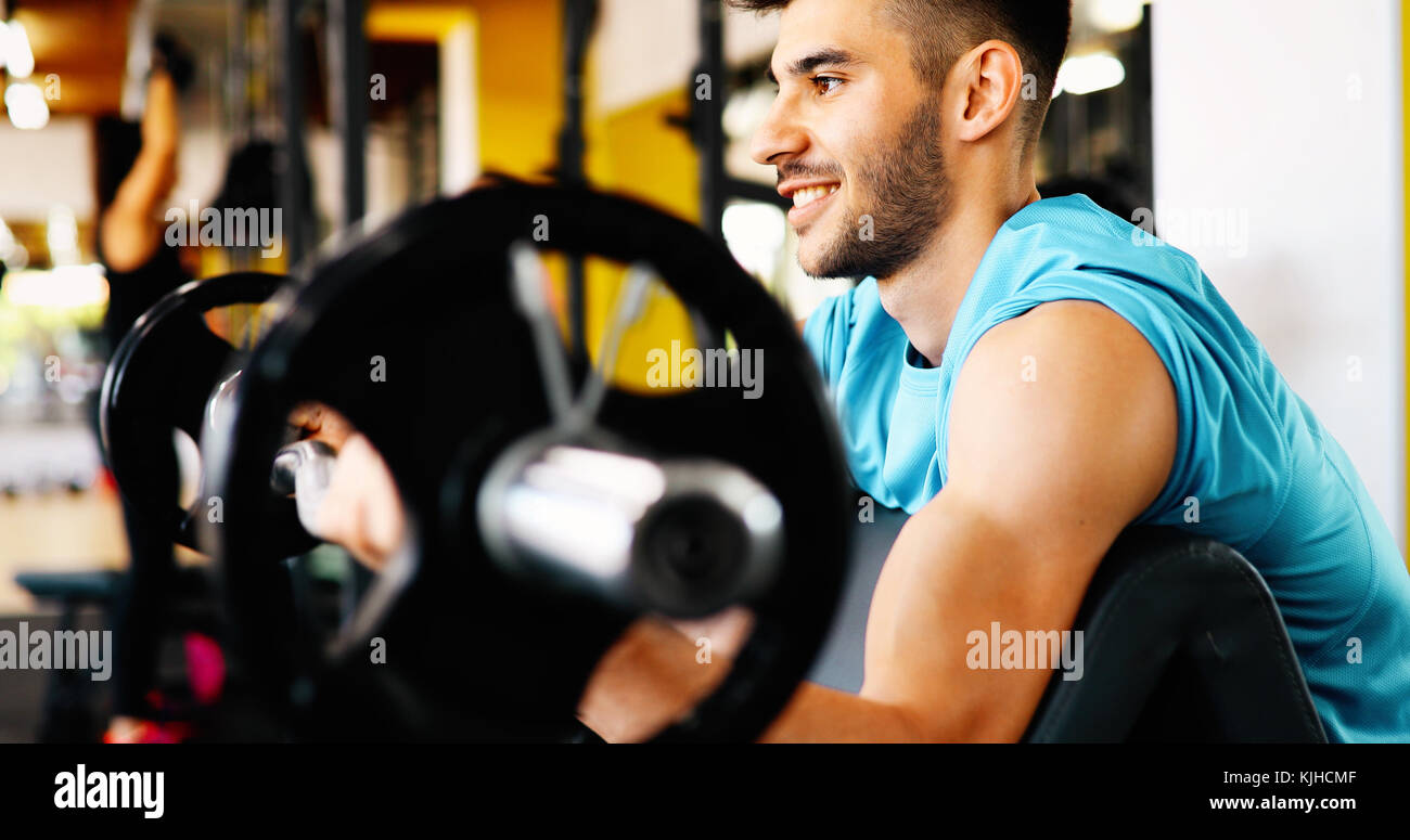Determined male working out in gym Stock Photo - Alamy
