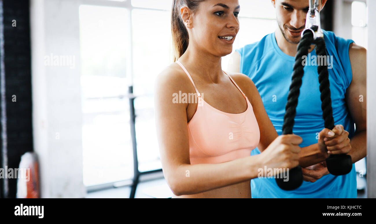 Personal trainer helping Stock Photo - Alamy