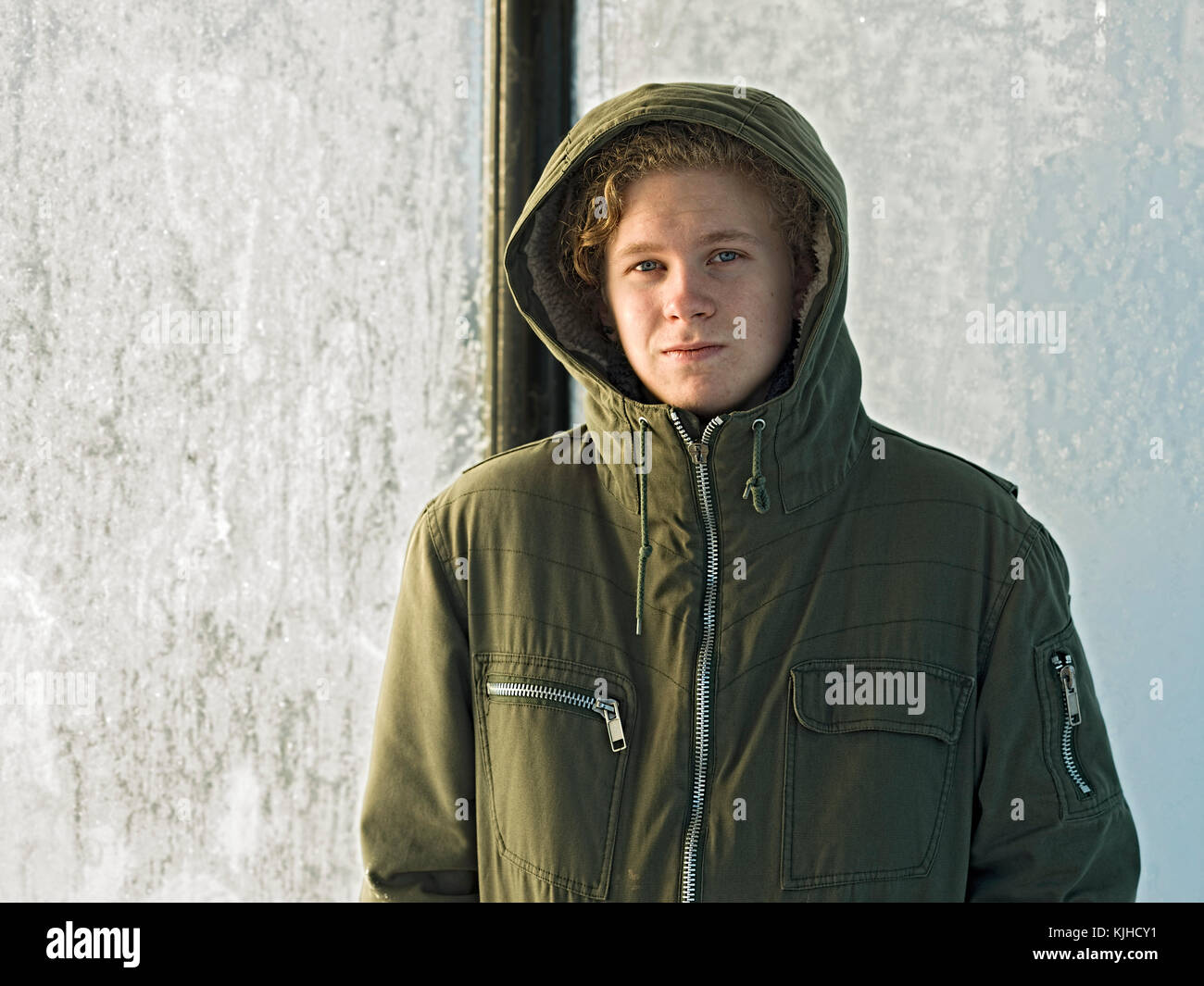 Freezing guy waiting at a bus stop Stock Photo - Alamy
