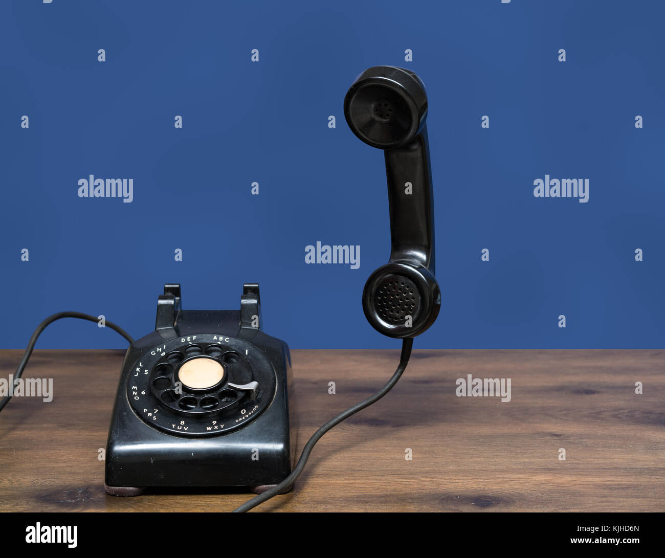 Antique old rotary dial telephone on wooden desk Stock Photo - Alamy