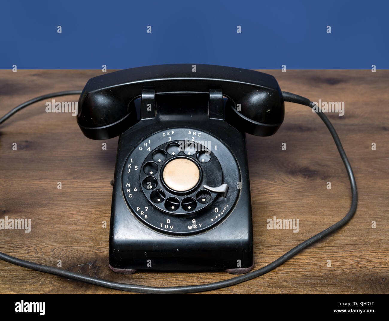 Antique old rotary dial telephone on wooden desk Stock Photo - Alamy