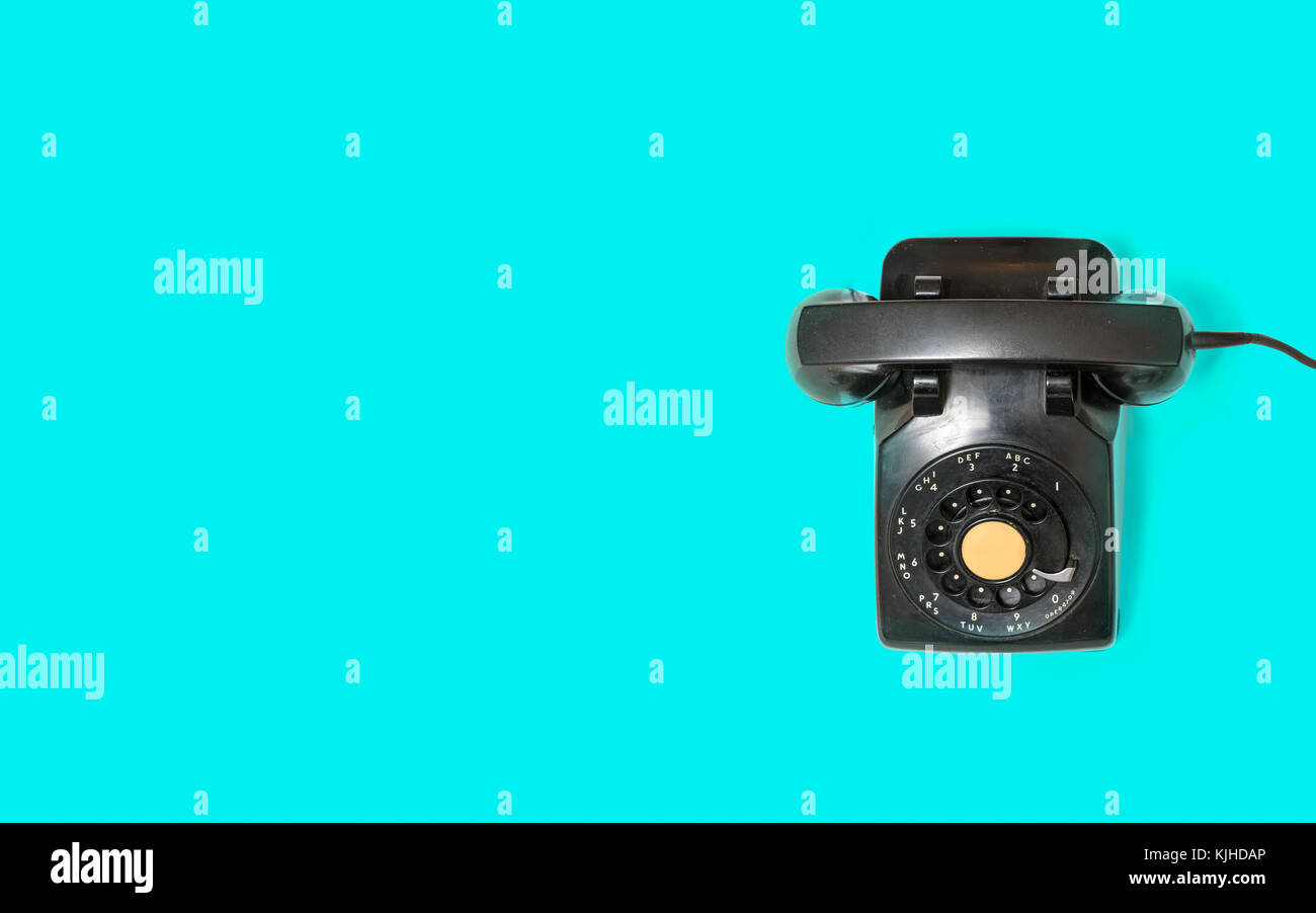 Antique old rotary dial telephone on turquoise background Stock Photo ...