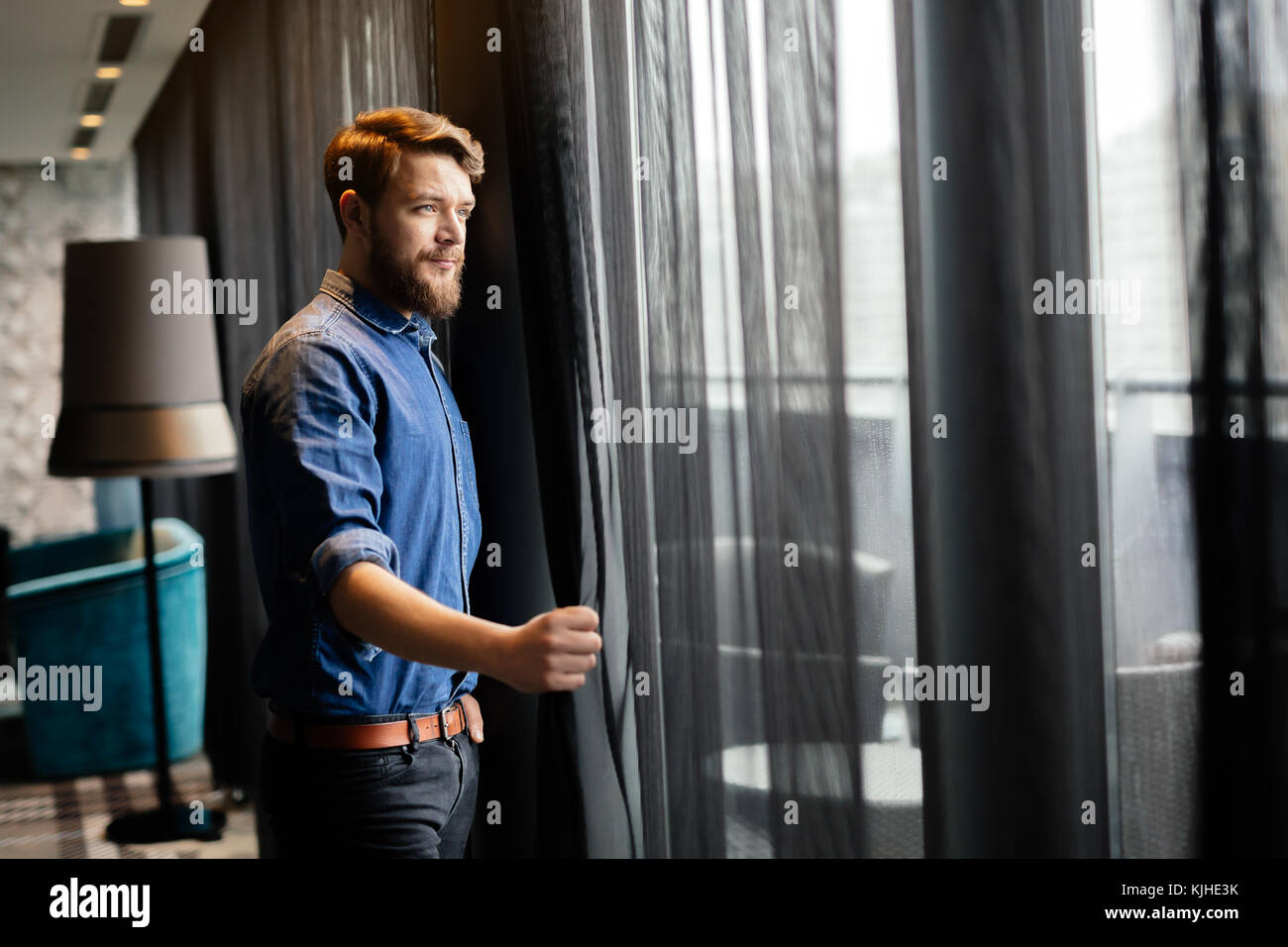 Man enjoying view from luxurious hotel room Stock Photo - Alamy
