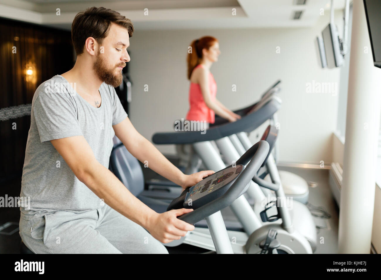 Male training on exercise bicycle hi-res stock photography and images ...