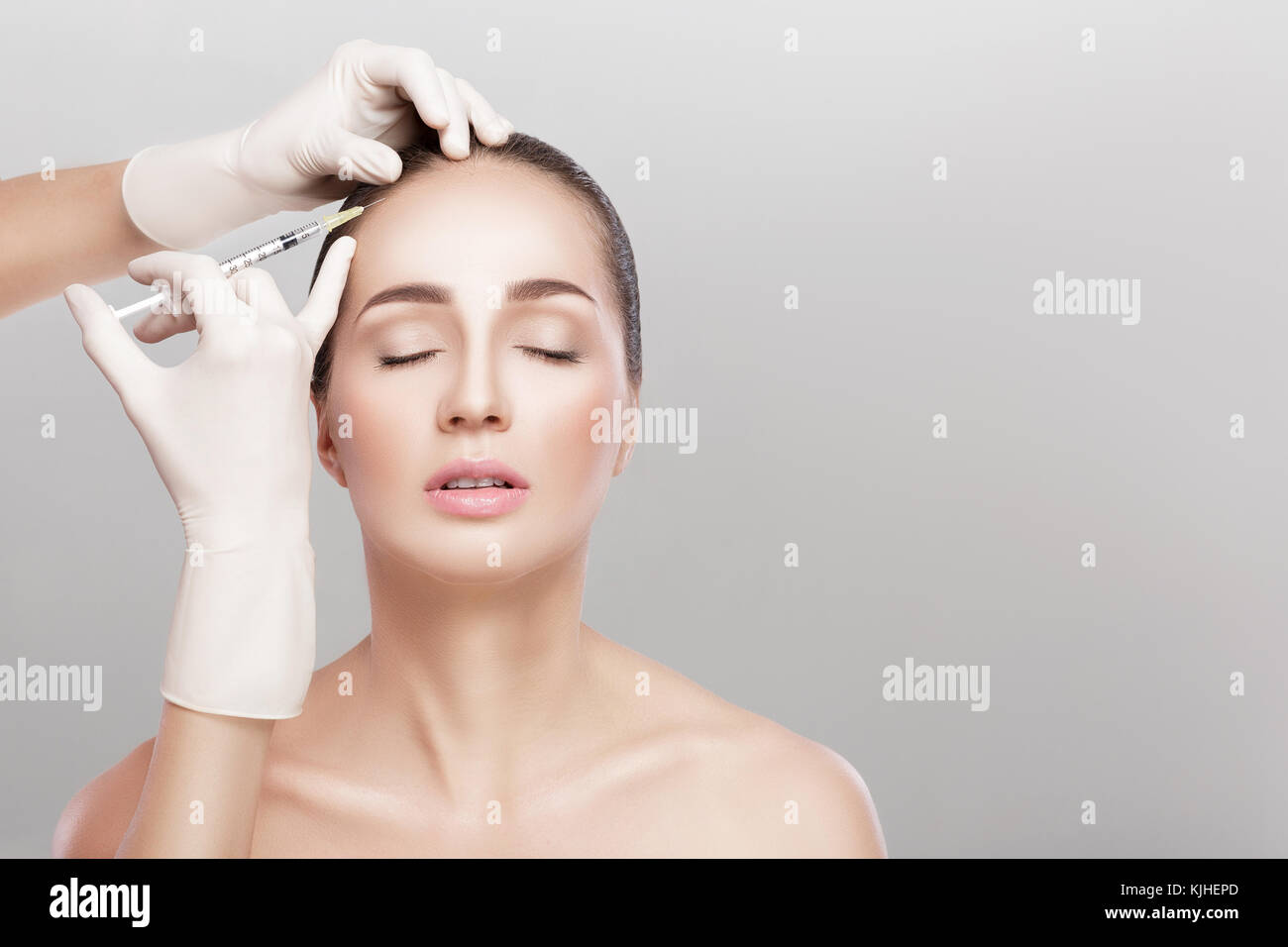 Cosmetic been injected in woman's head Stock Photo - Alamy