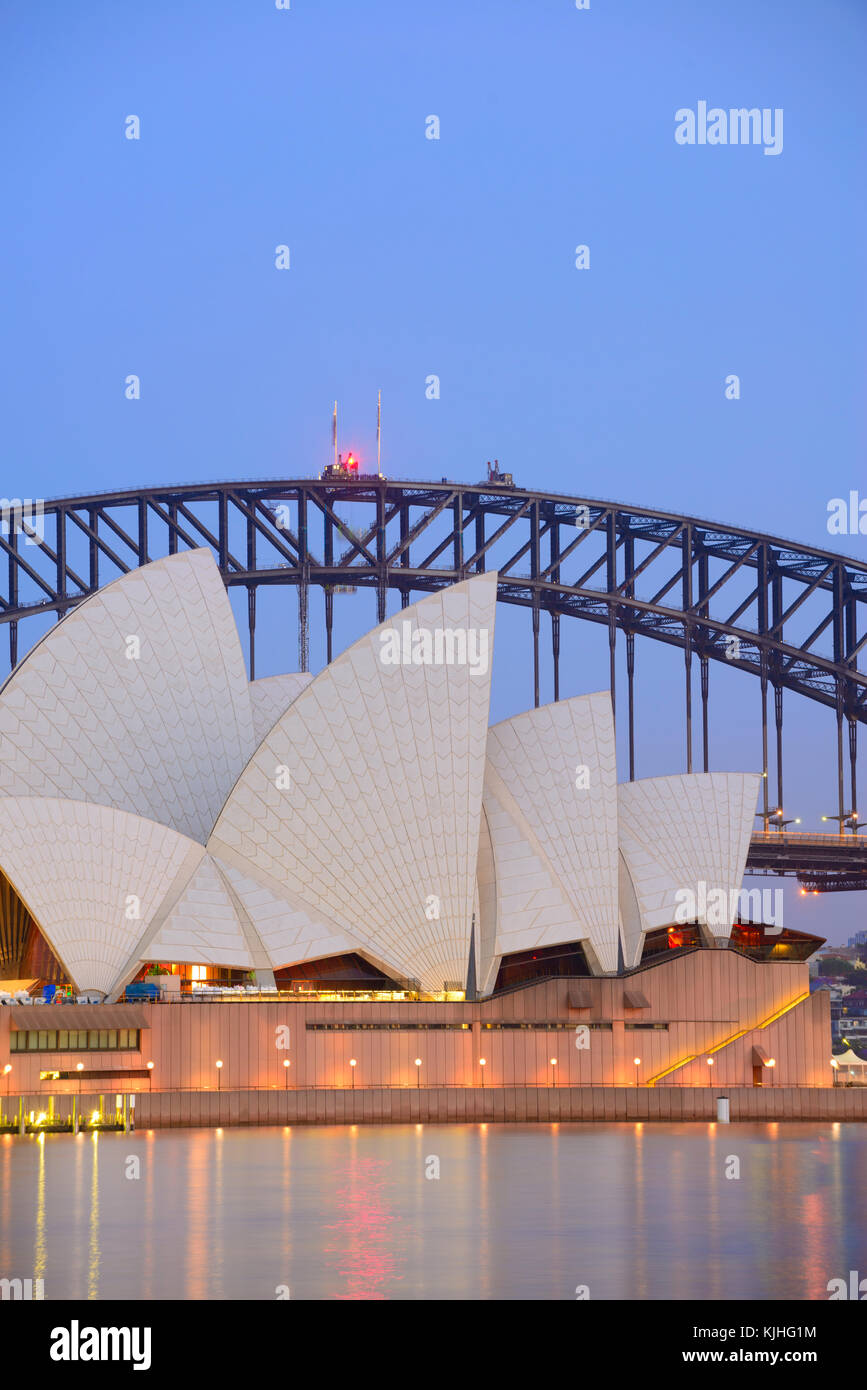 The illuminated sydney opera house with harbor bridge at sunset hi-res ...