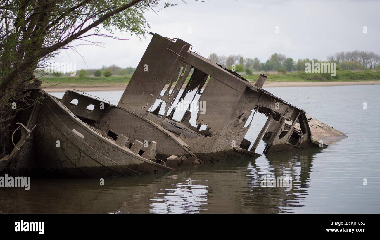 sunken boat on river bed Stock Photo - Alamy