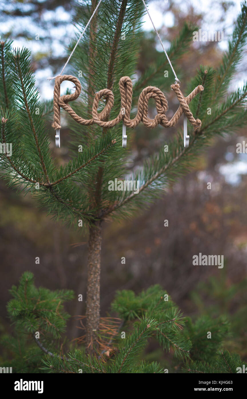 Word relax on tree in the forest Stock Photo - Alamy