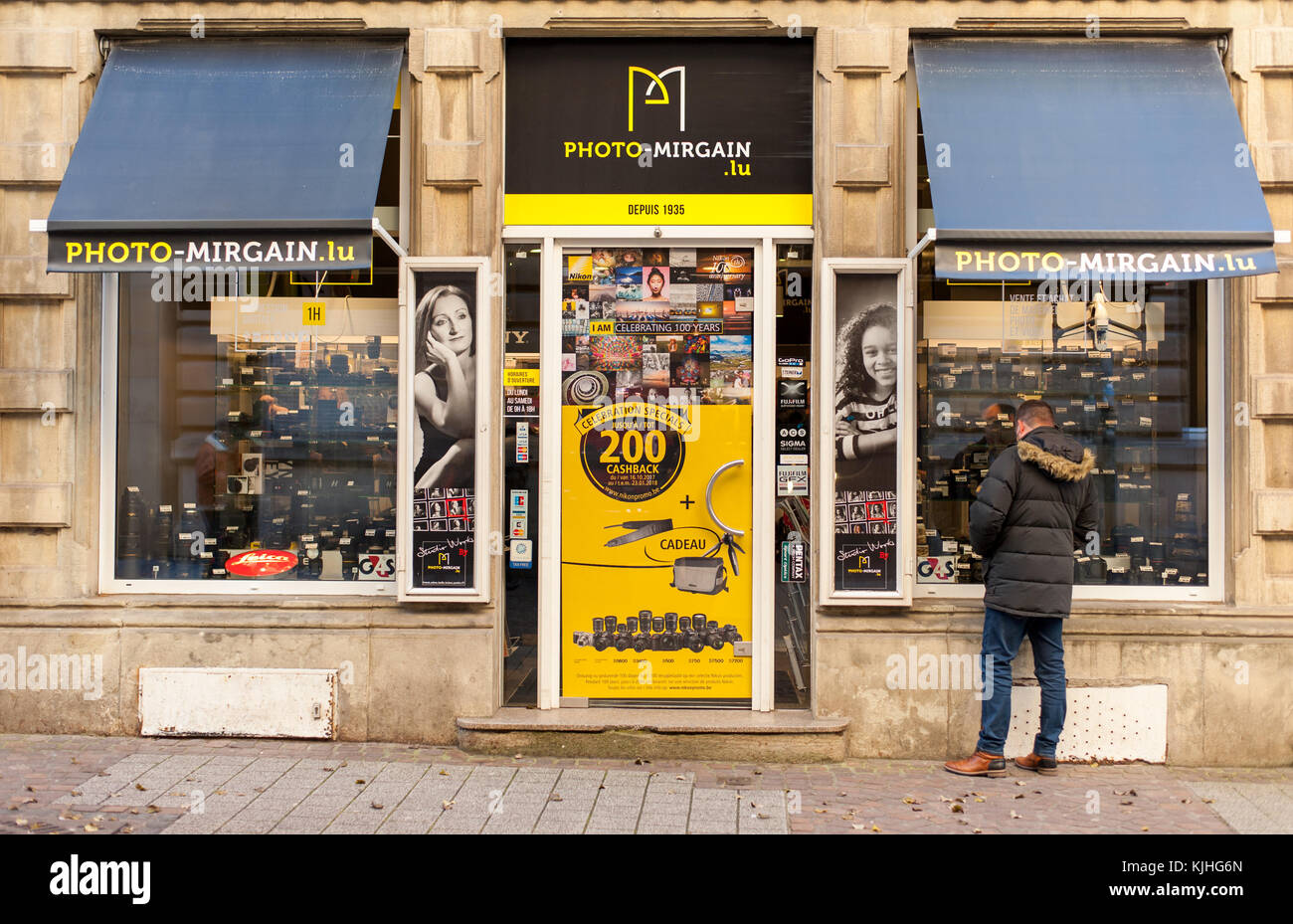 A man looking for a camera in front of a camera store Stock Photo - Alamy