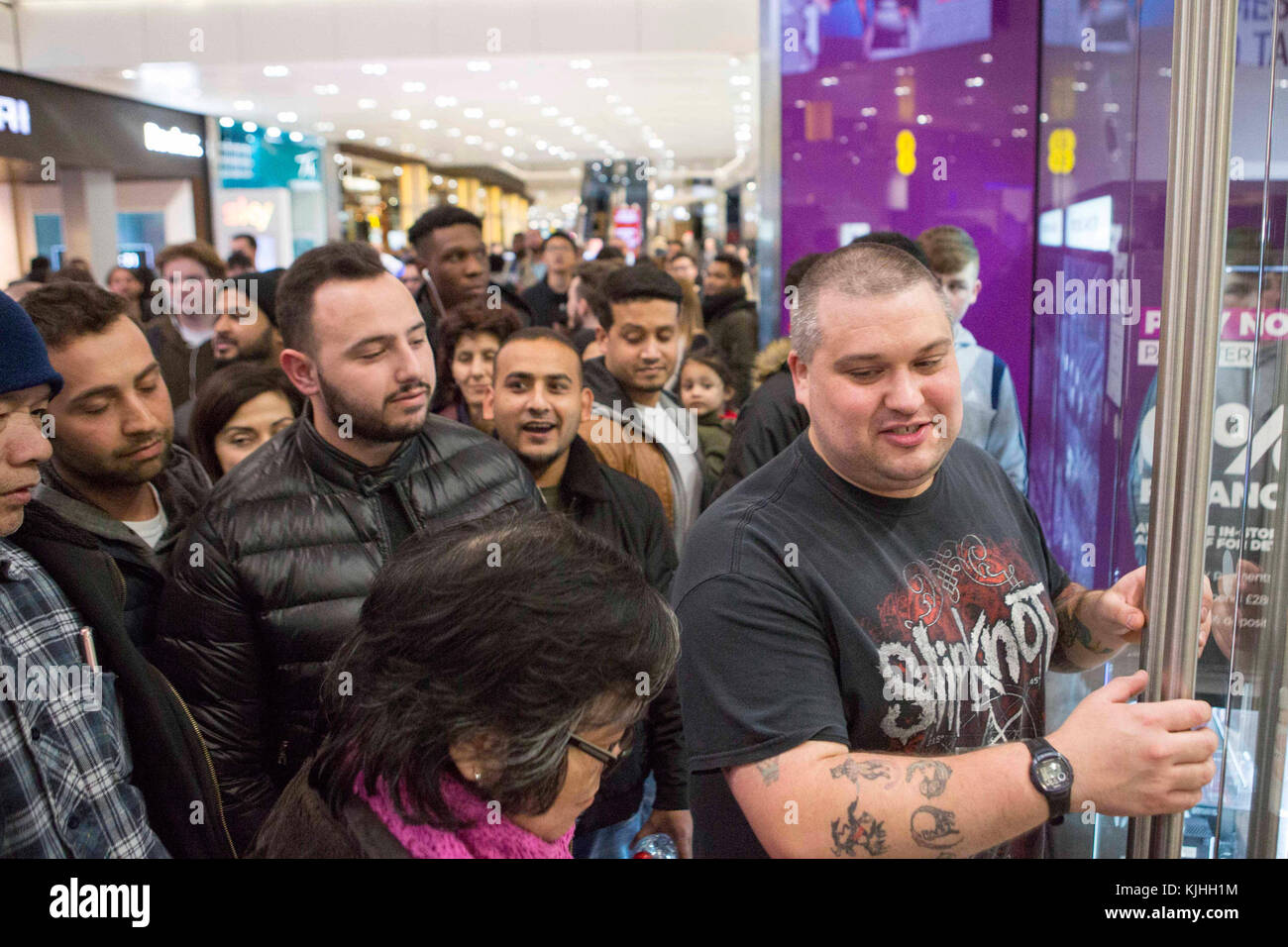 Shoppers wait outside the entrance to leading games retailer GAME in ...