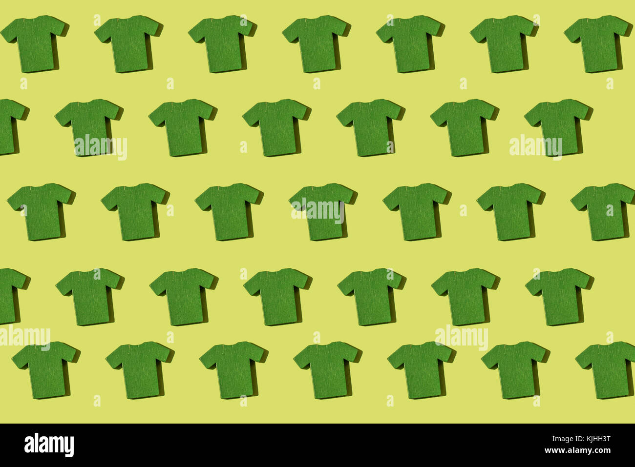 Green T-shirt repeated pattern background Stock Photo - Alamy