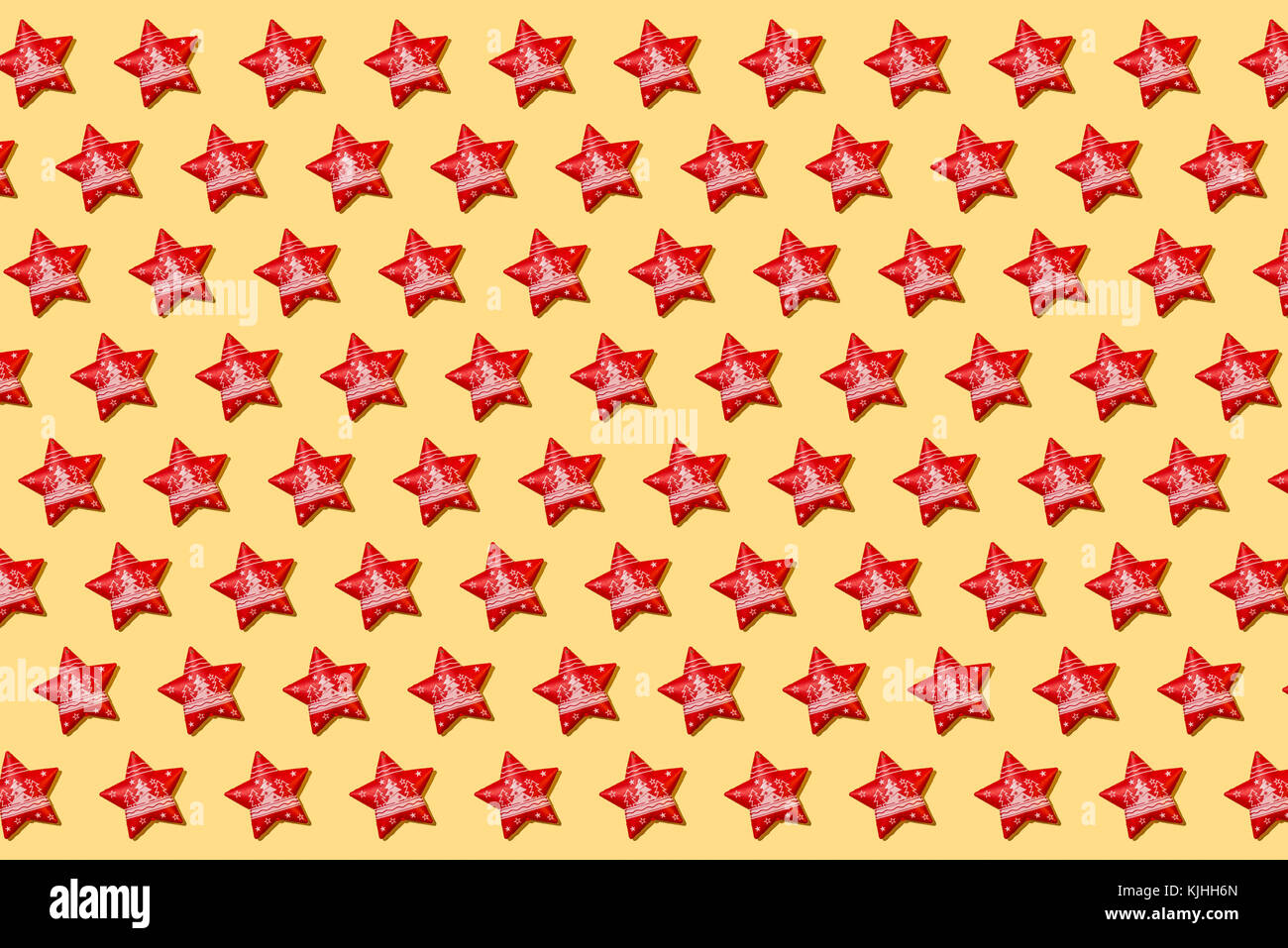 Christmas star repeated pattern on yellow background Stock Photo - Alamy