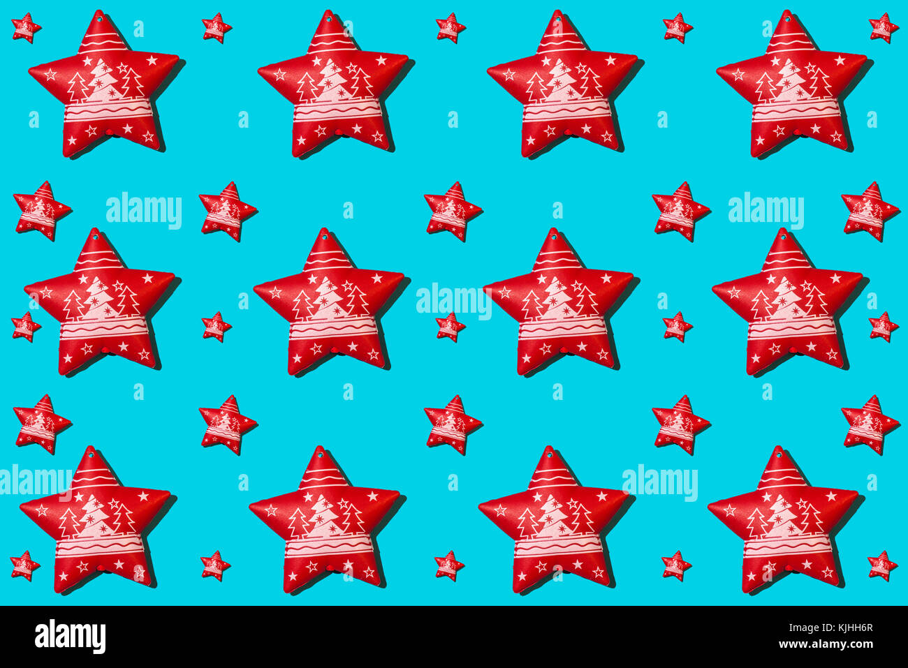Red Christmas star repeated pattern on blue background Stock Photo - Alamy