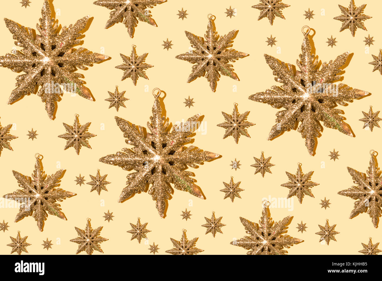 Snowflakes repeated on yellow background pattern Stock Photo - Alamy