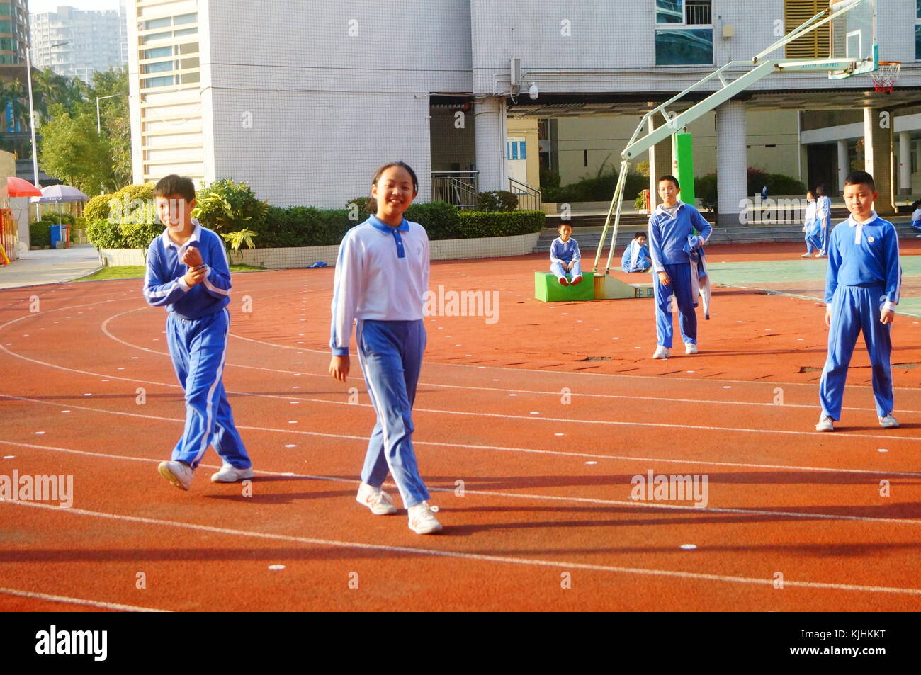 The pupils are having PE lessons on the school playground, and the ...