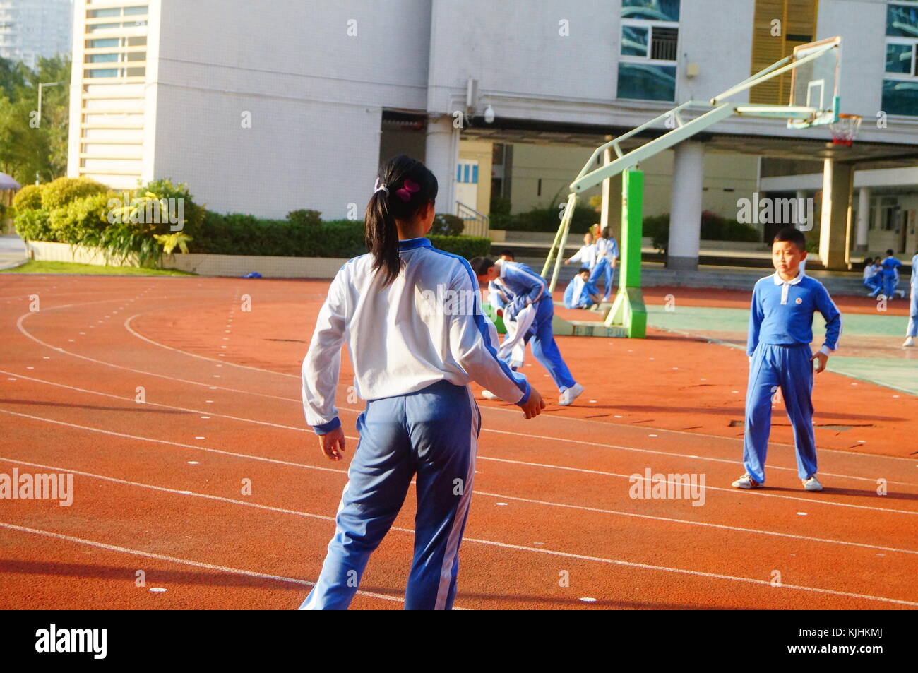 The pupils are having PE lessons on the school playground, and the ...